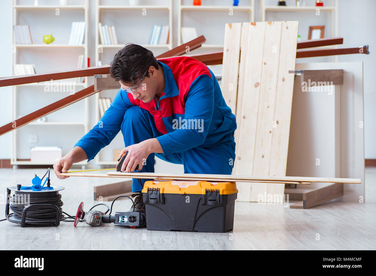 Young carpenter working with wooden planks Stock Photo - Alamy