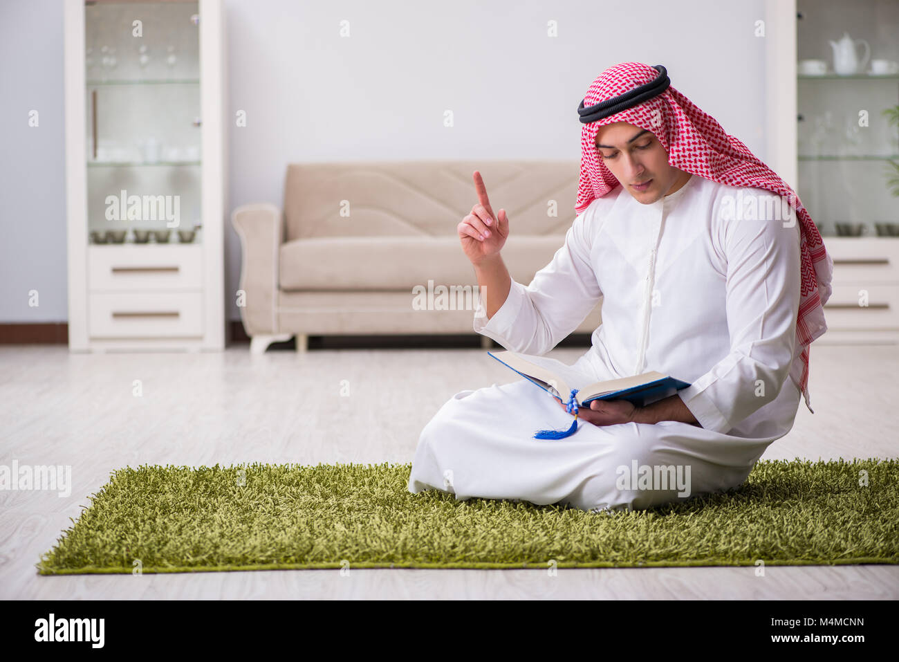 Arab man praying at home Stock Photo - Alamy