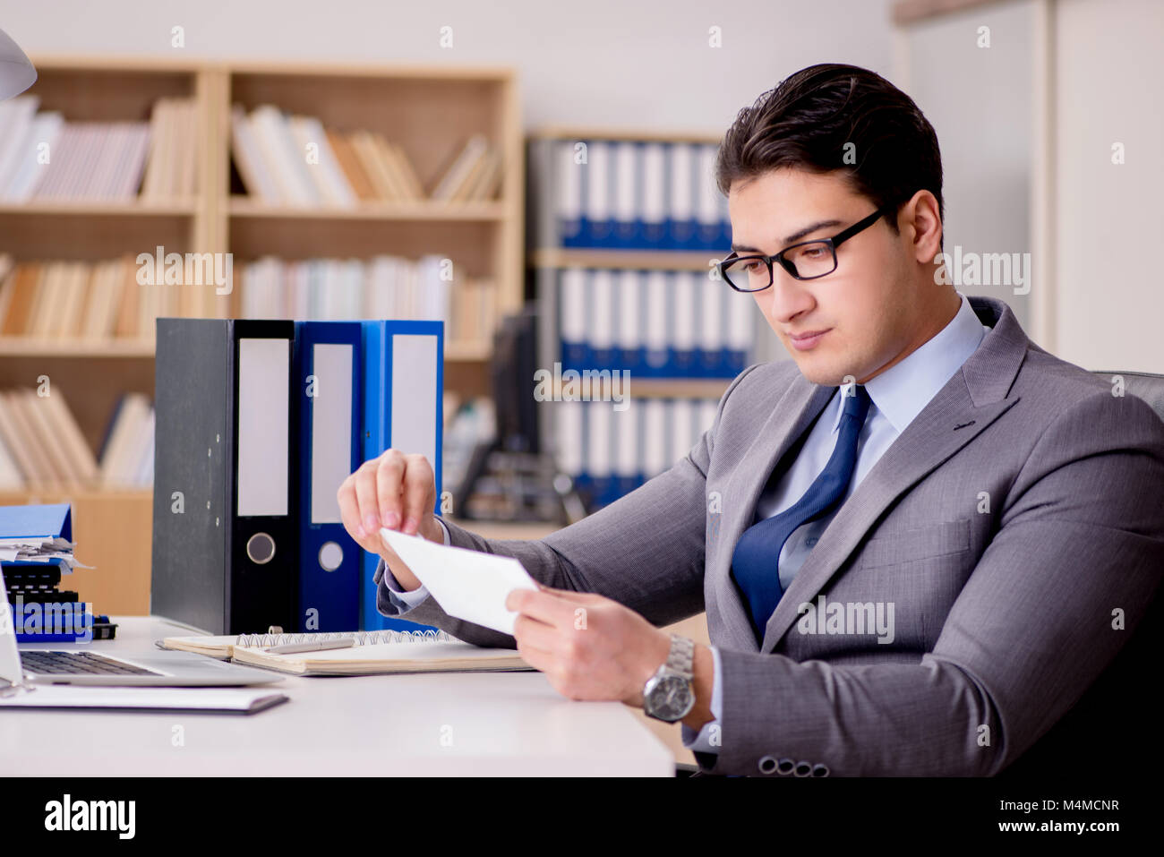 Businessman receiving letter envelope in office Stock Photo - Alamy