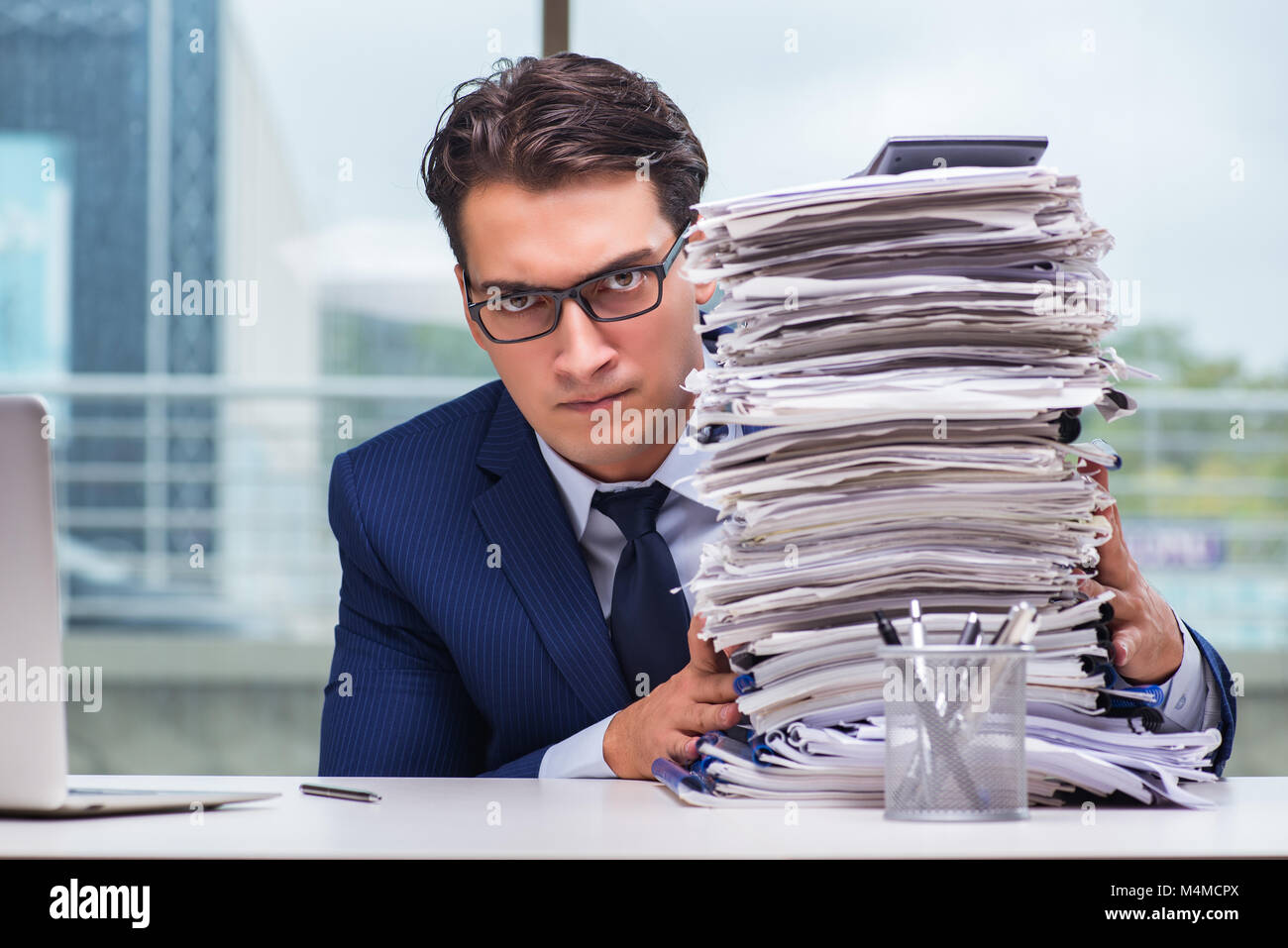 Businessman with pile stack of paper paperwork in the office Stock ...