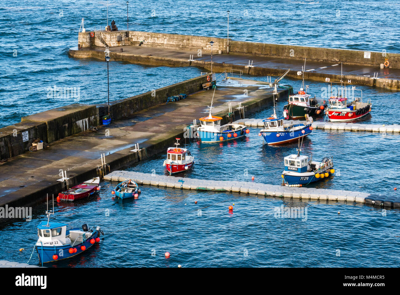View of colourful small fishing boats in harbour, picturesque seaside ...