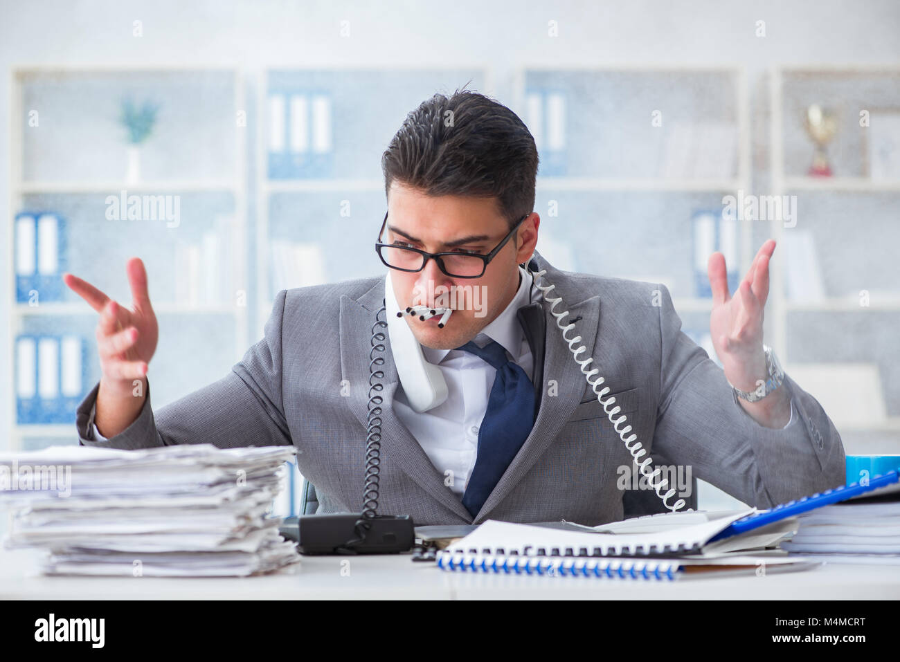 Businessman smoking in office at work Stock Photo - Alamy