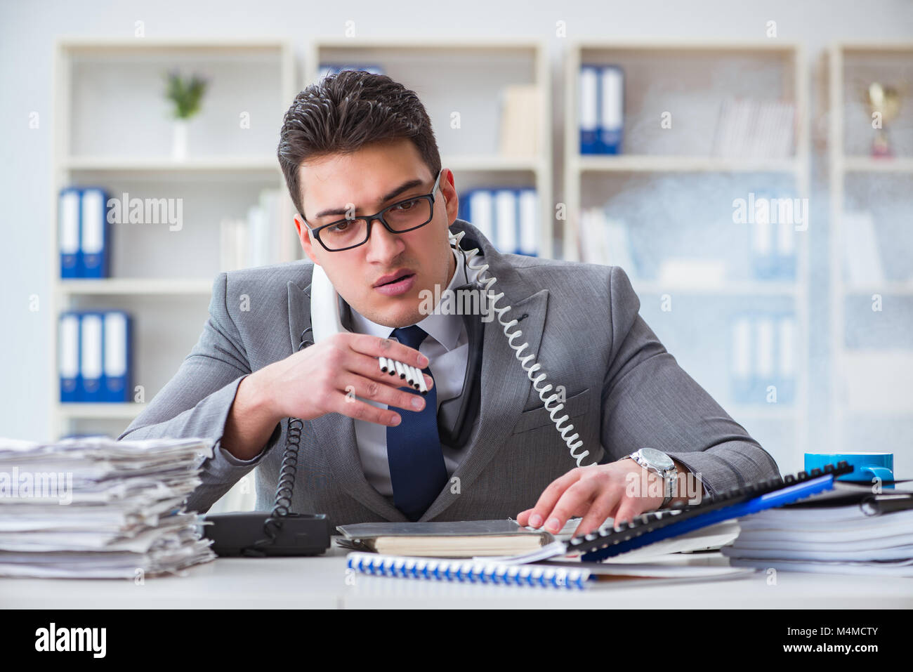 Businessman smoking in office at work Stock Photo - Alamy