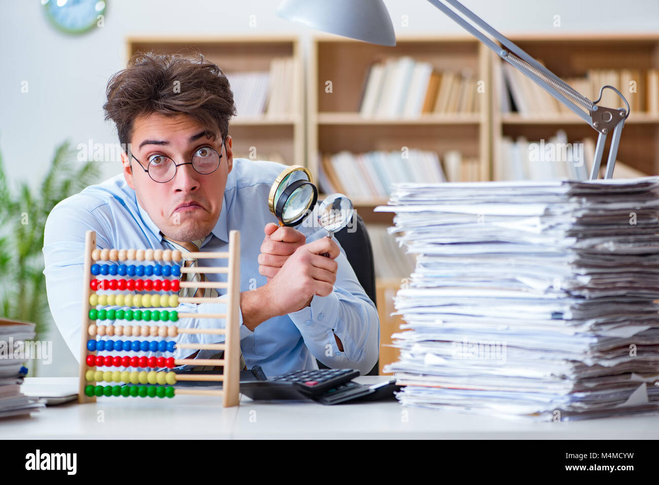 Mad auditor looking for errors in the report Stock Photo - Alamy