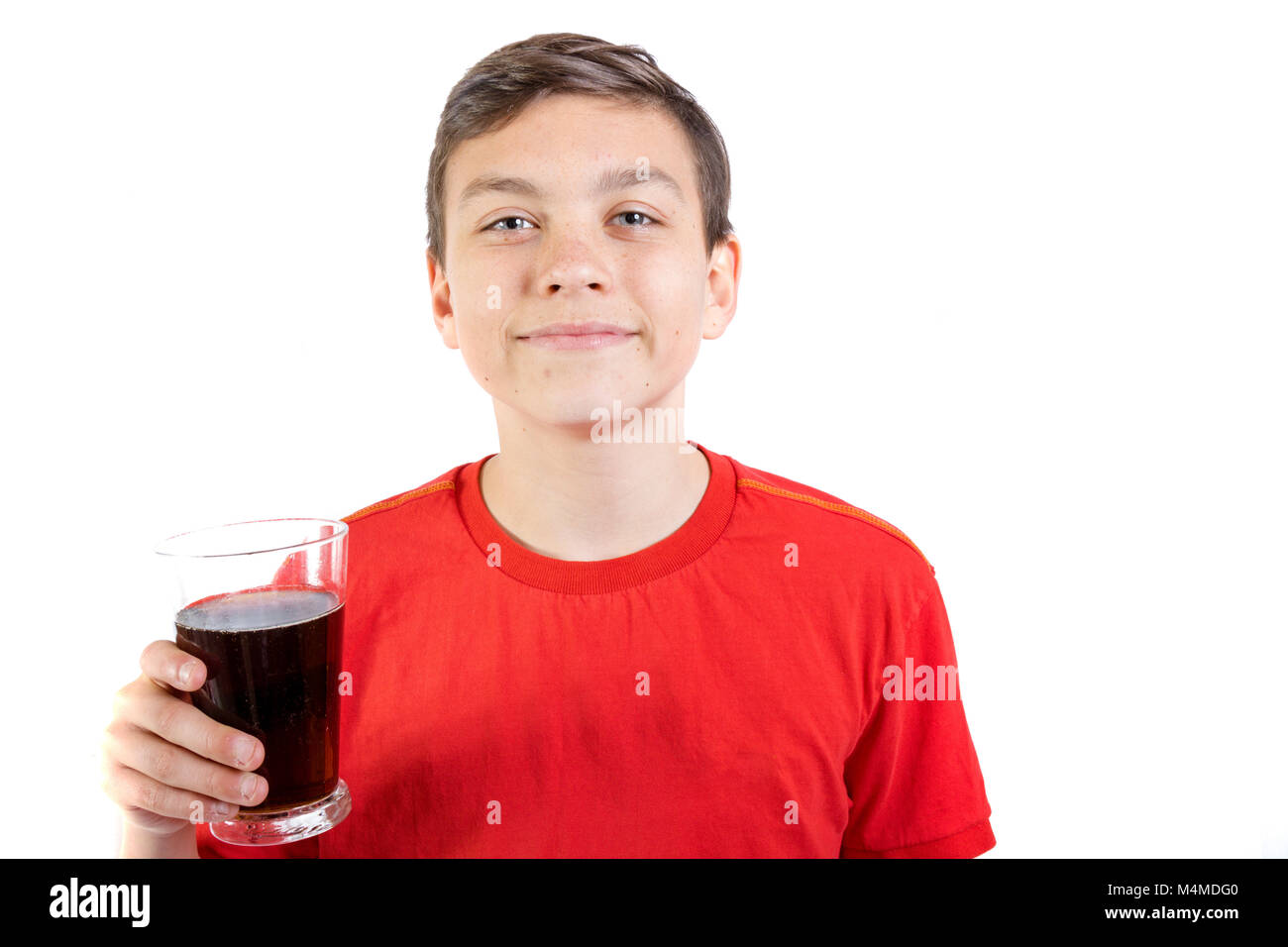 Young caucasian teenage boy drinking a glass of cola drink Stock Photo ...