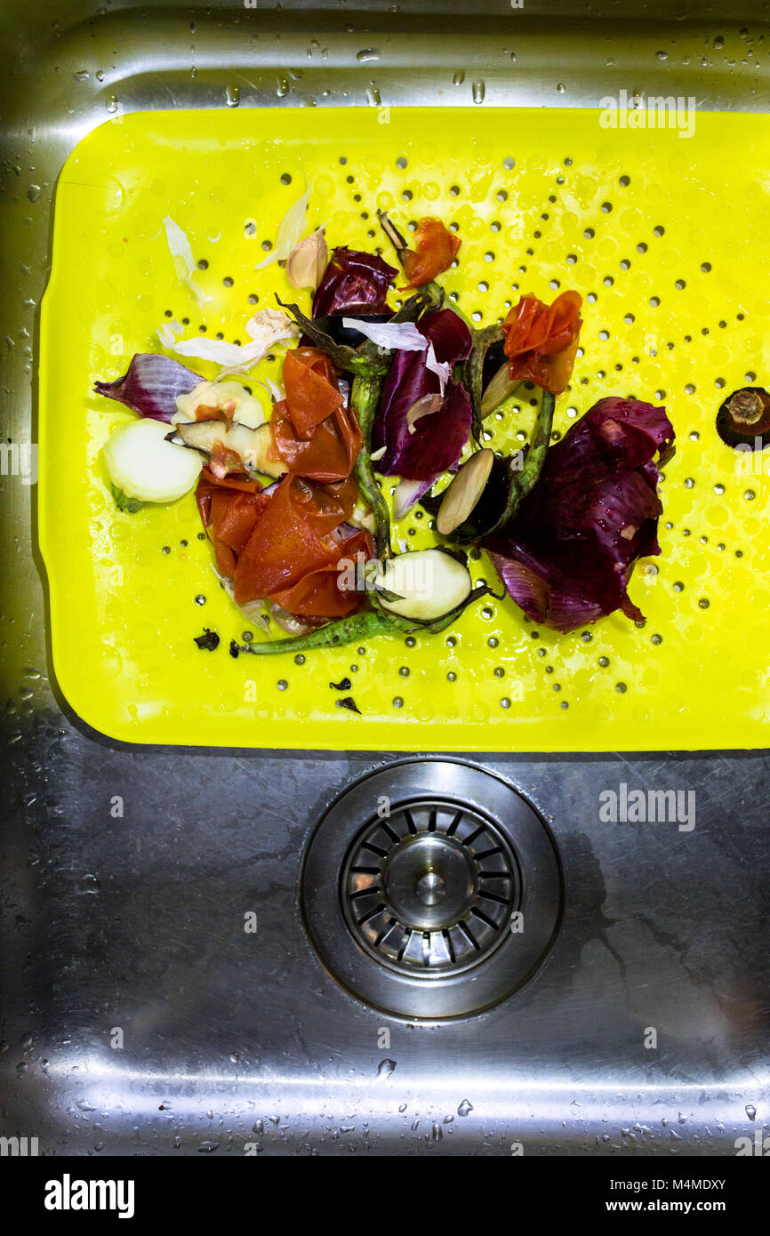 View of plastic dish in a sink full of domestic bio food waste, ready ...