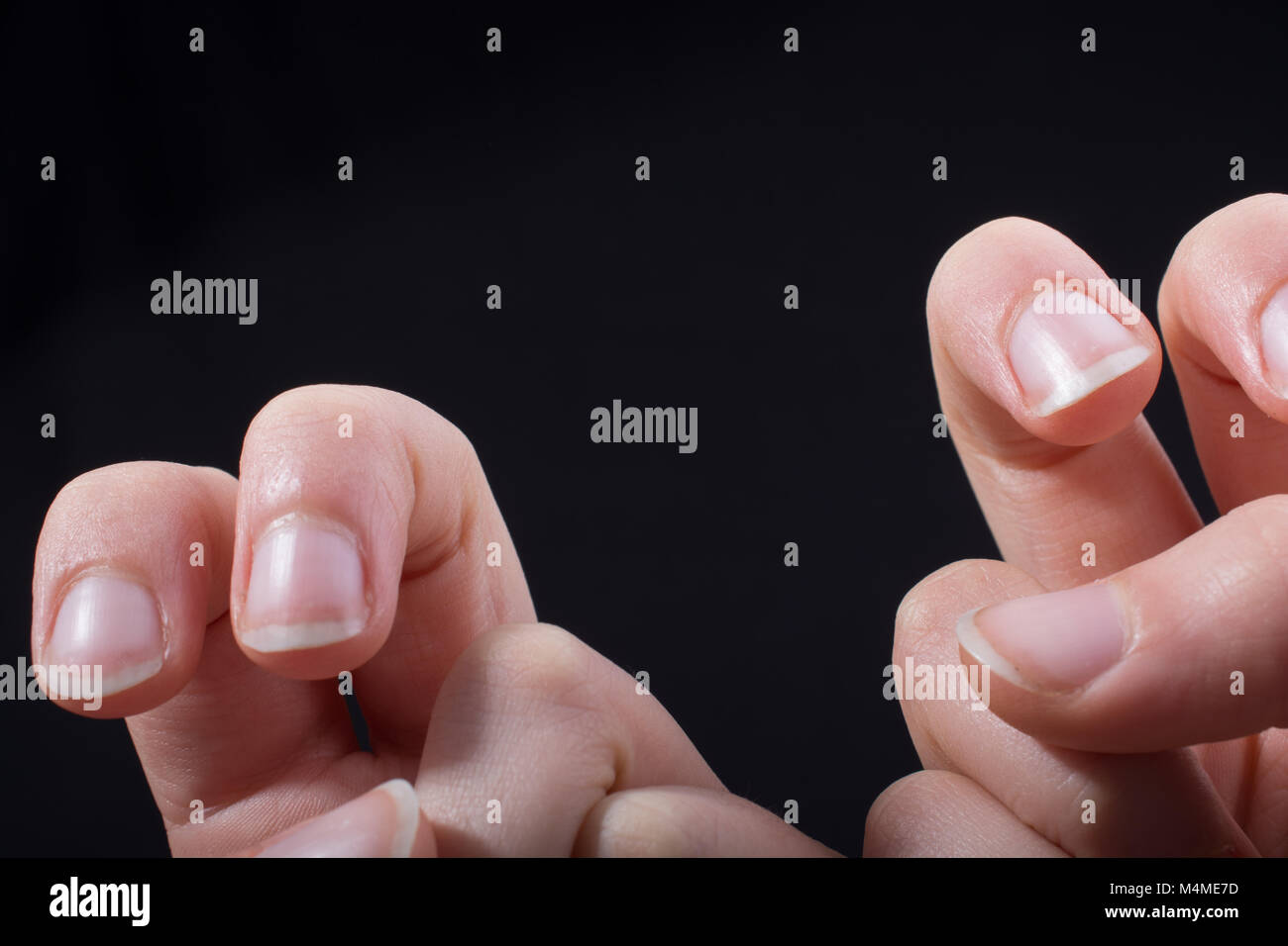 Two fingers of a child hand partly seen in black background Stock Photo ...