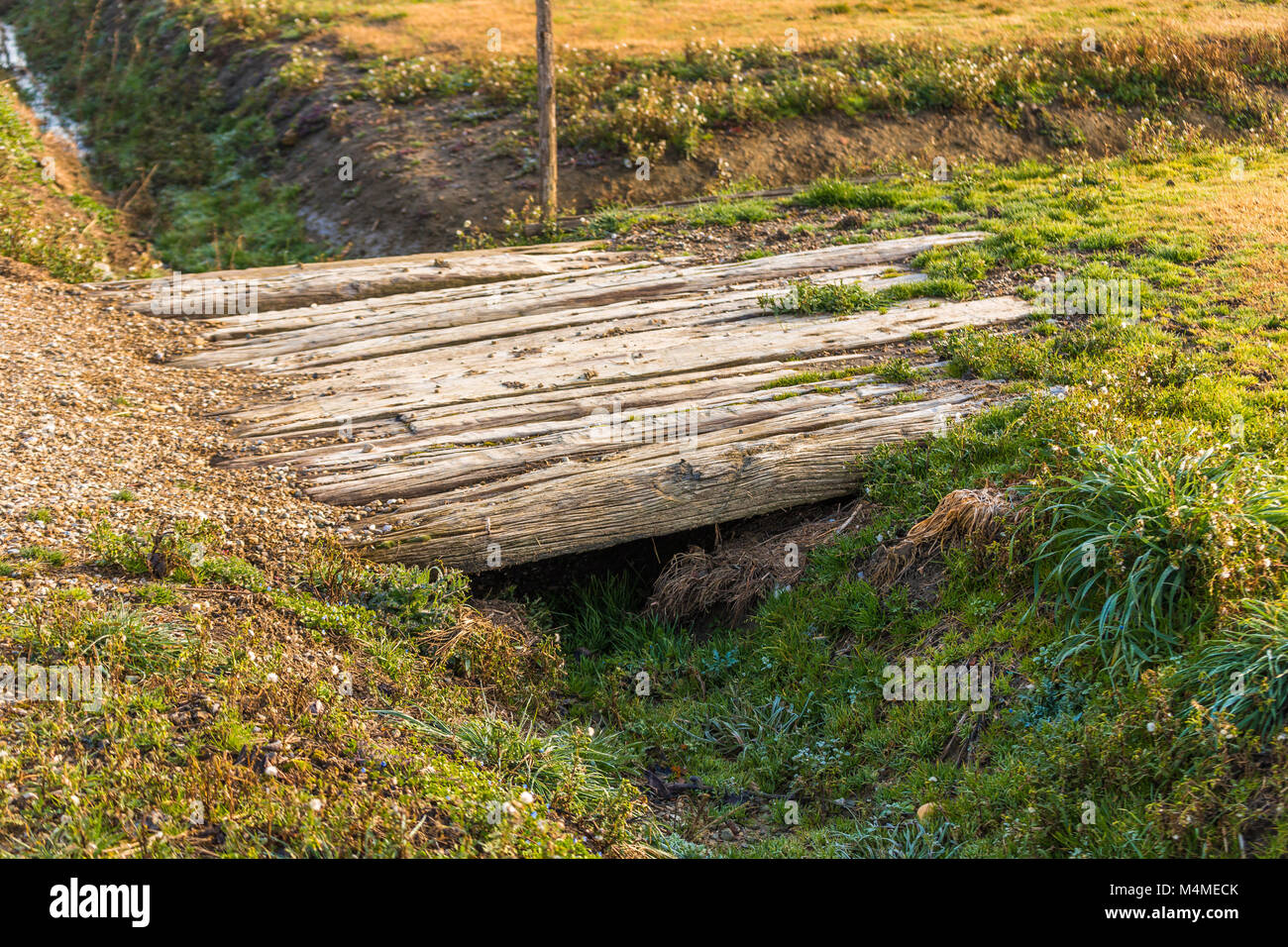 Bridge of old wooden planks on a irrigation ditch in countryside Stock ...