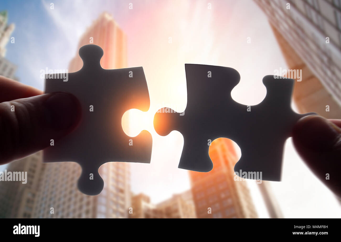 Putting puzzle pieces together Stock Photo - Alamy