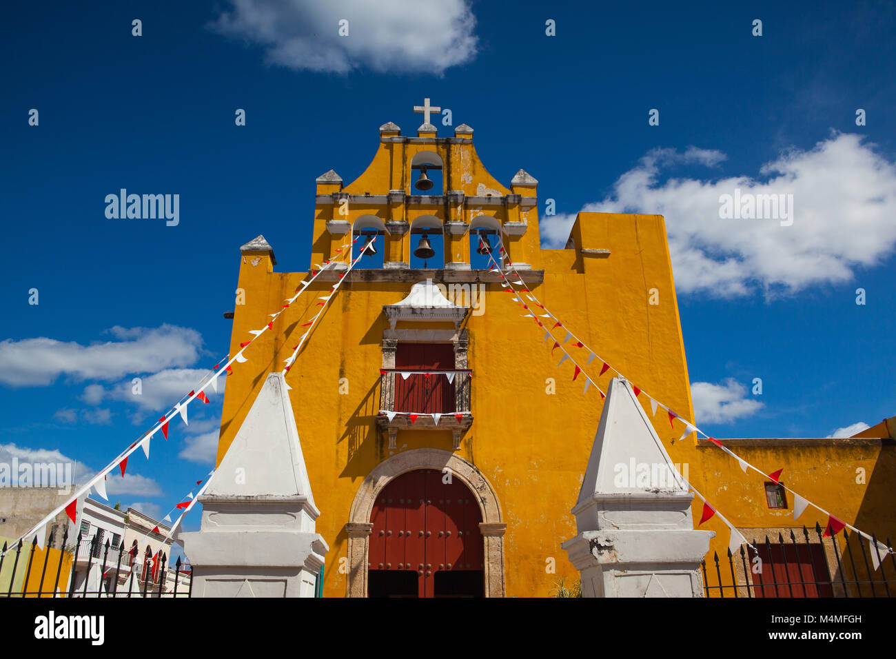 Yellow colonial church with a deep blue sky in Campeche, Mexico. The ...
