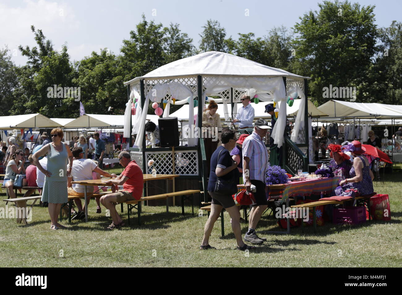 People in traditional clothes making music on a fair Stock Photo - Alamy