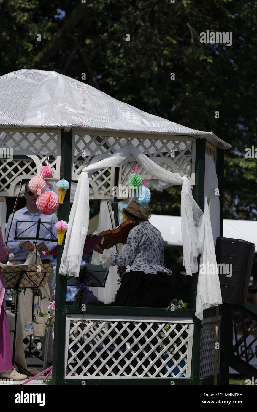 People in traditional clothes making music on a fair Stock Photo - Alamy