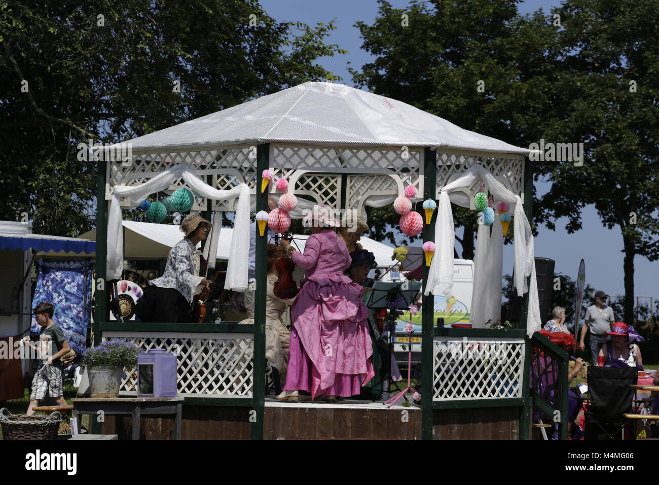 People in traditional clothes making music on a fair Stock Photo - Alamy