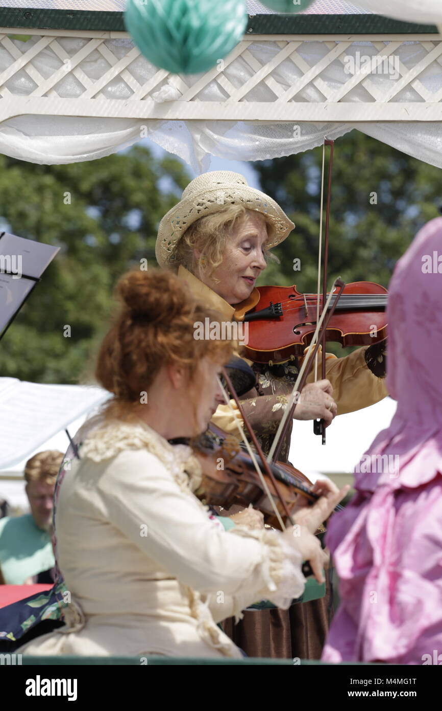 People in traditional clothes making music on a fair Stock Photo - Alamy
