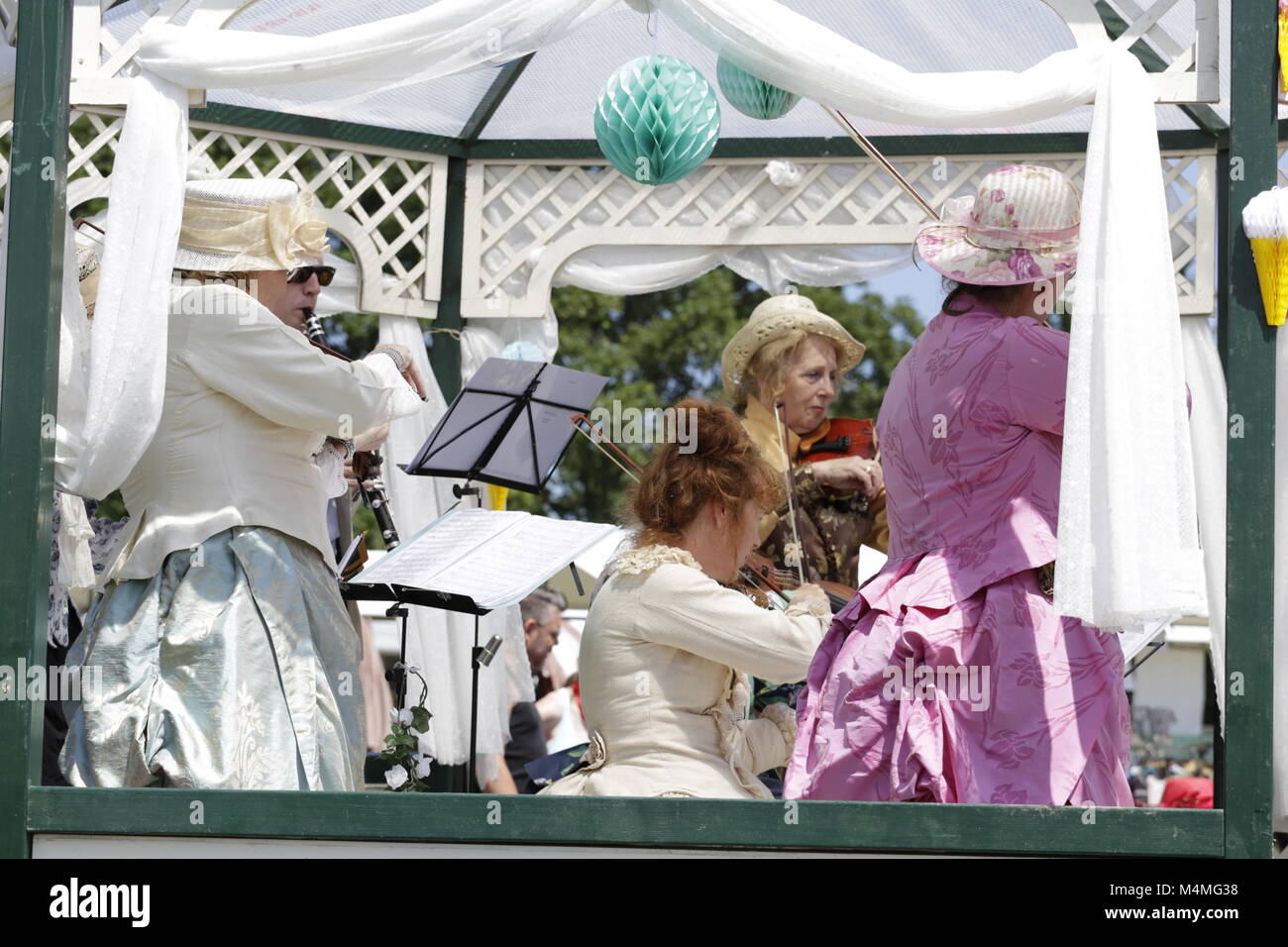 People in traditional clothes making music on a fair Stock Photo - Alamy