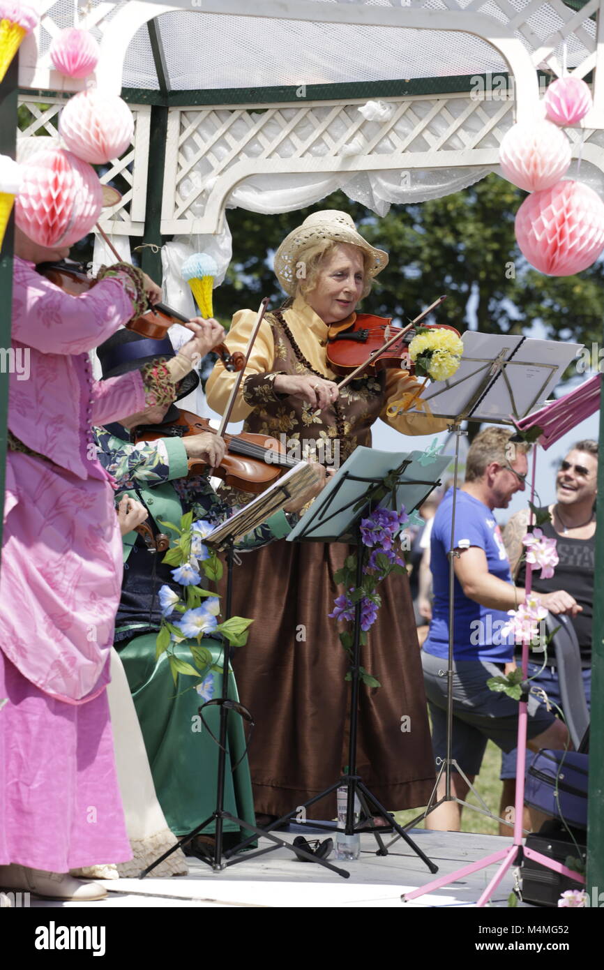 People in traditional clothes making music on a fair Stock Photo - Alamy