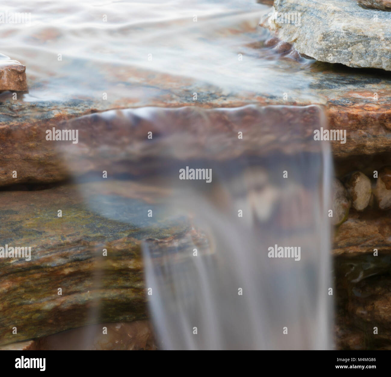 Single sheet of water flowing over a small and rocky waterfall Stock ...