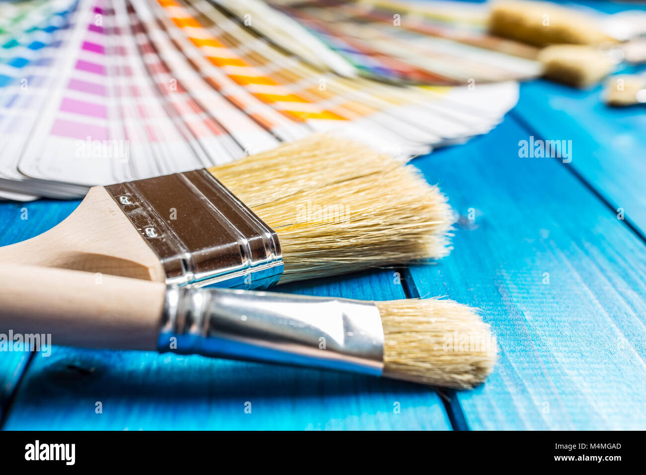Paint cans color palette, cans opened with brushes on blue table Stock ...