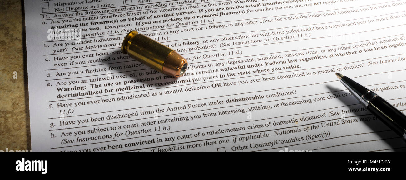 Handgun cartridge and pen with mental health question on gun background ...