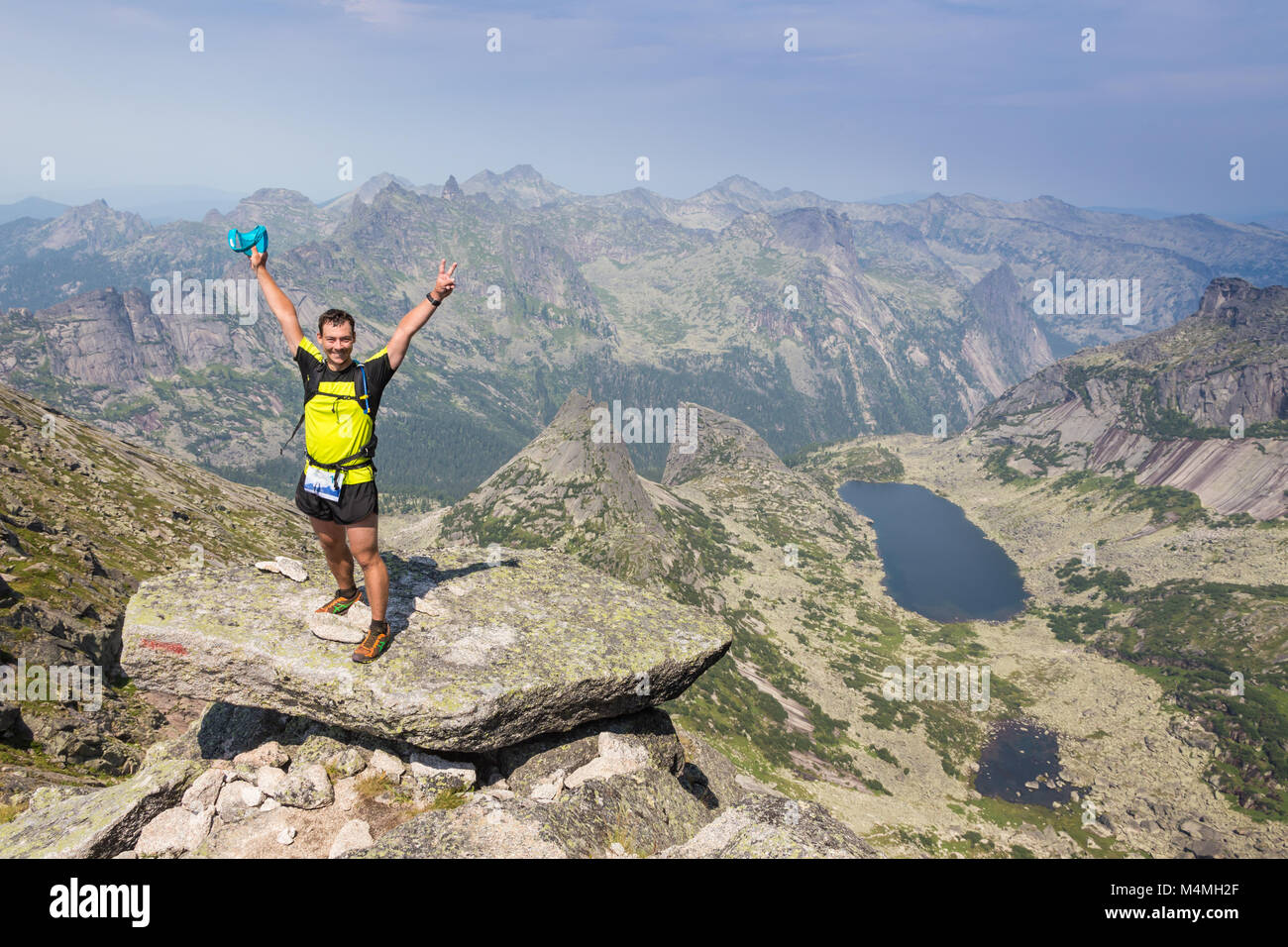 Man on the top of hill watching wonderful scenery in mountains during ...