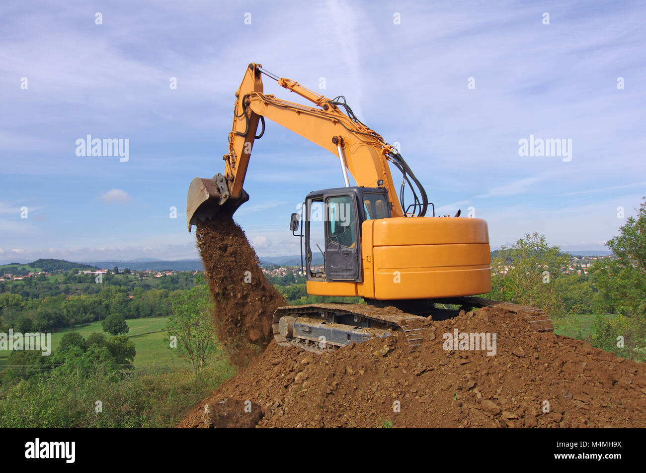 Excavator in action during earth moving works Stock Photo - Alamy