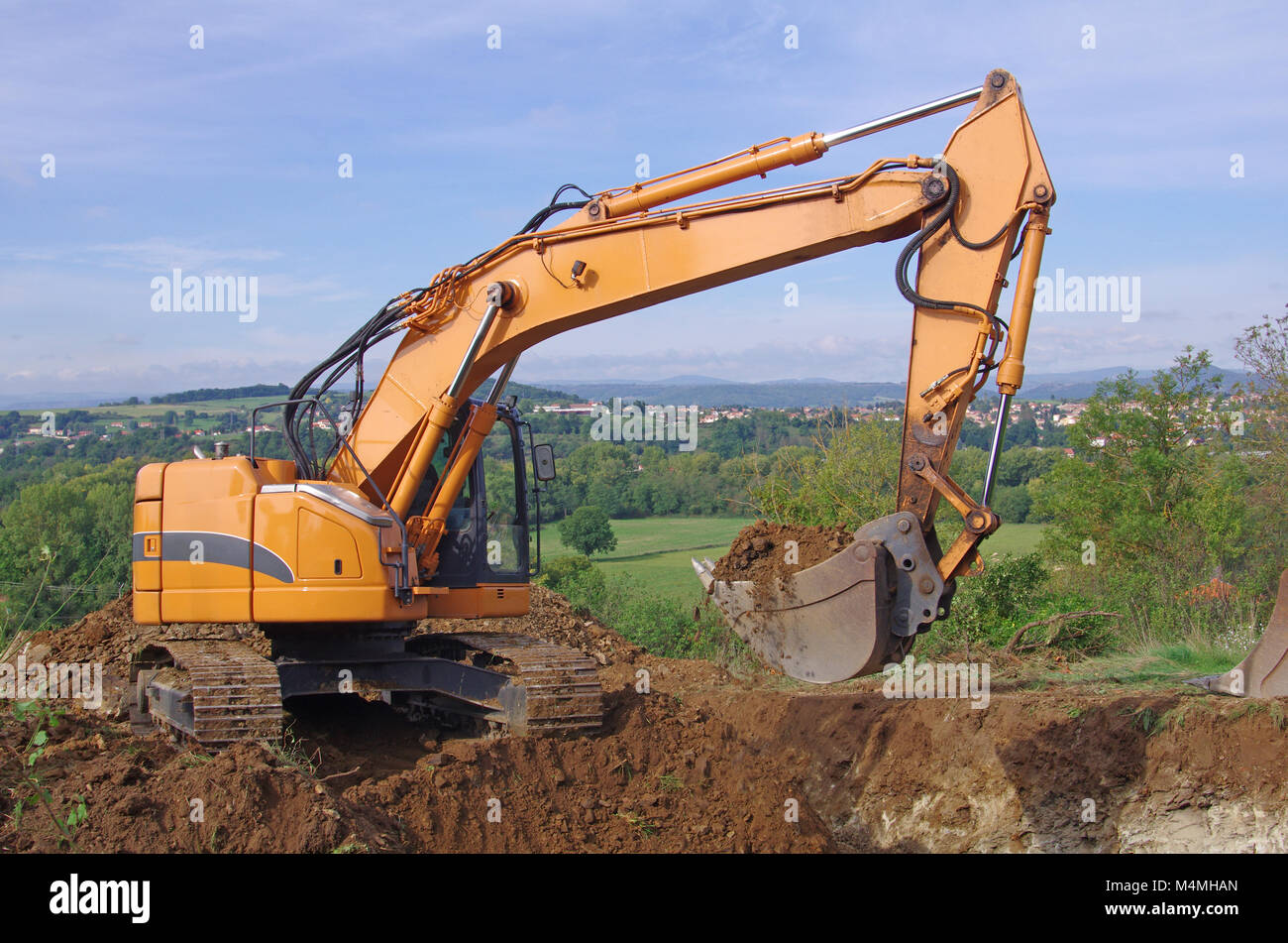 Excavator in action during earth moving works Stock Photo - Alamy
