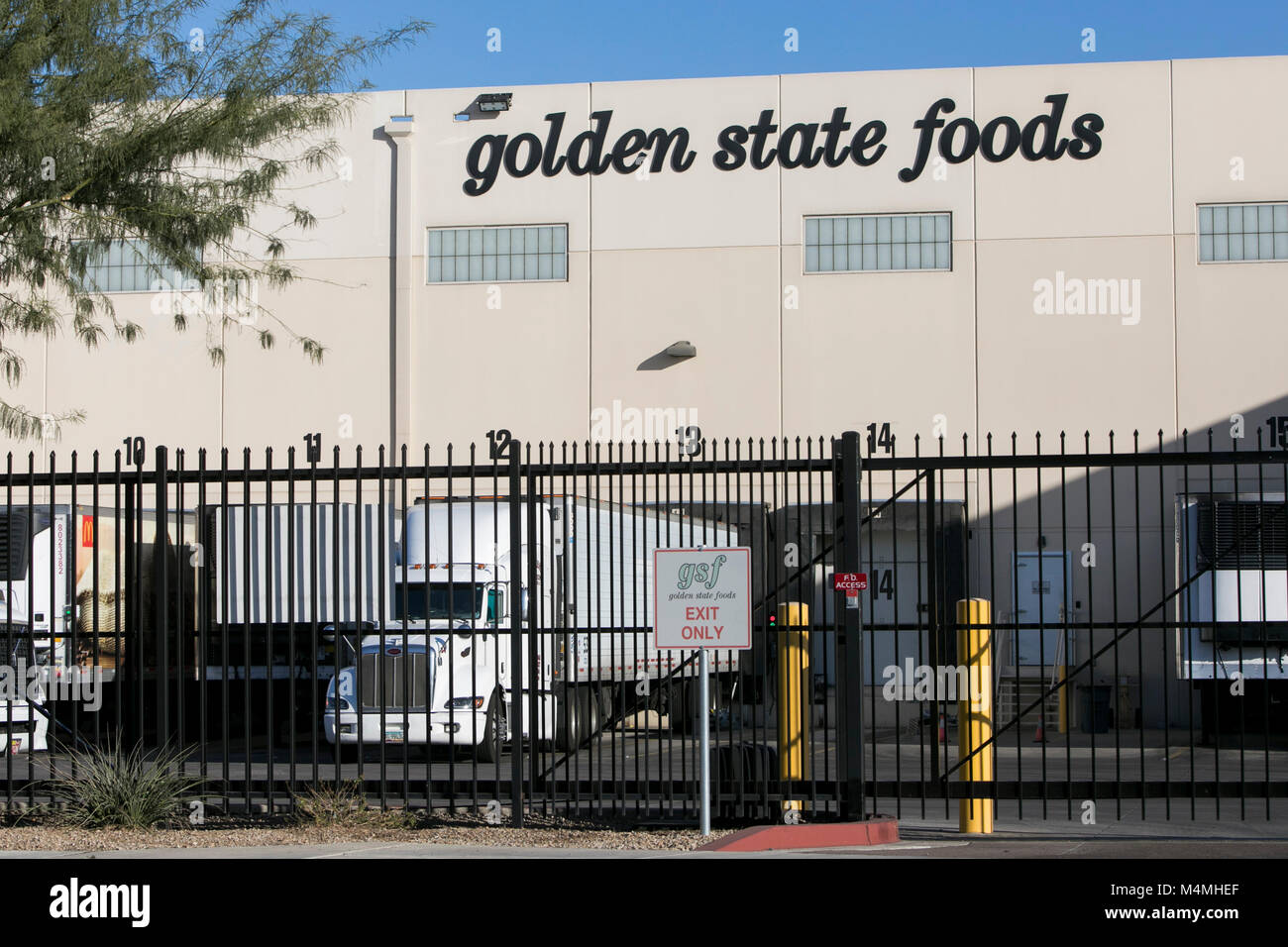 A logo sign outside of a facility occupied by Golden State Foods in ...