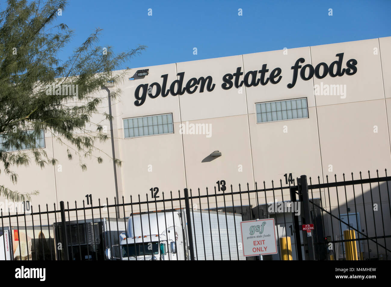A logo sign outside of a facility occupied by Golden State Foods in ...