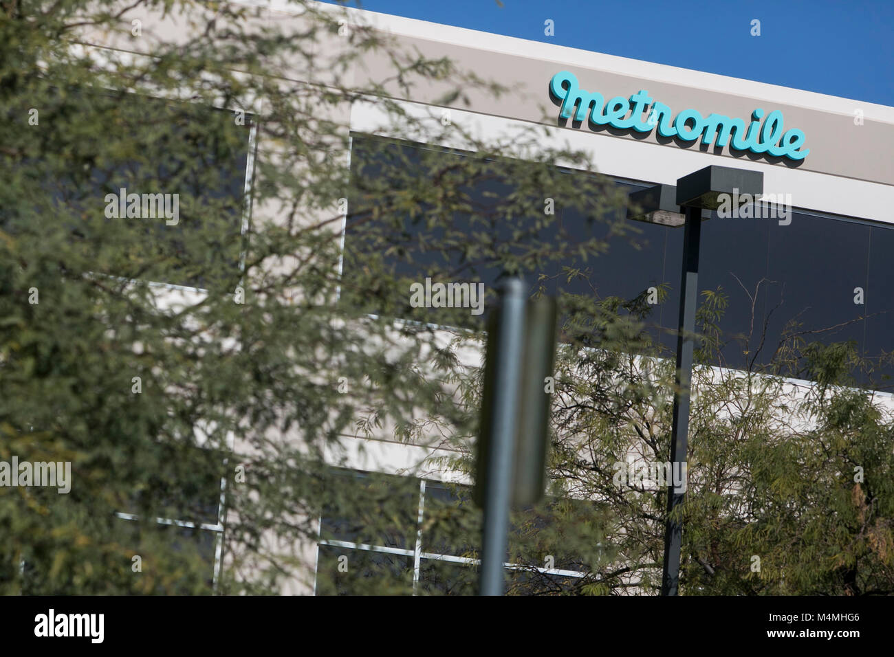 A logo sign outside of a facility occupied by Metromile in Tempe ...