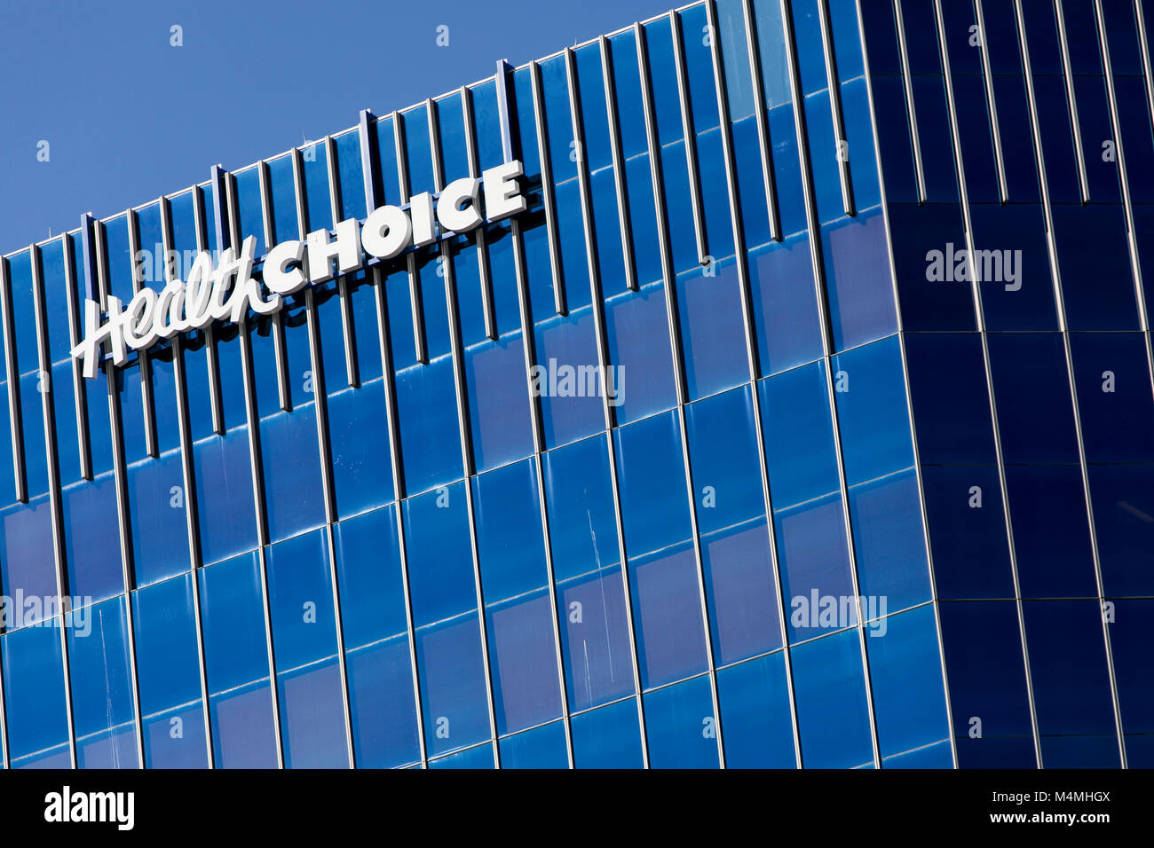 A logo sign outside of a facility occupied by Health Choice in Phoenix ...