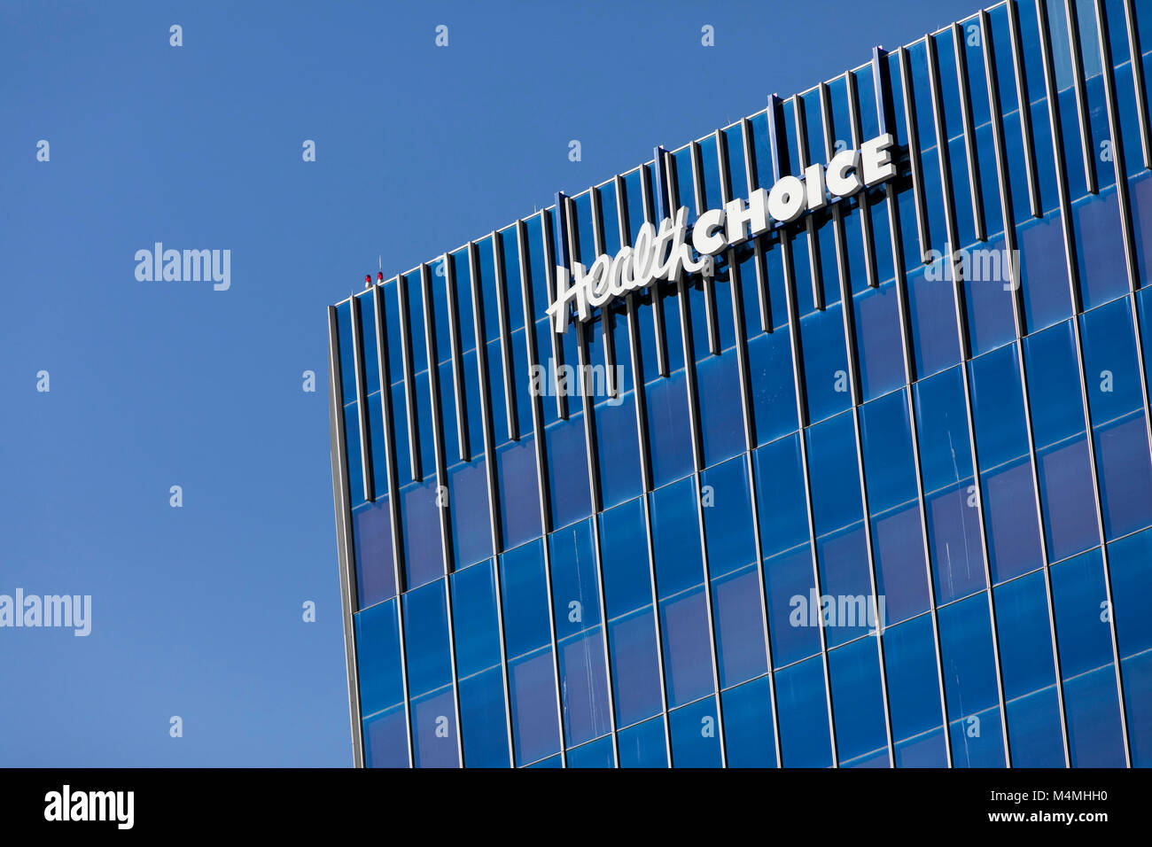 A logo sign outside of a facility occupied by Health Choice in Phoenix ...