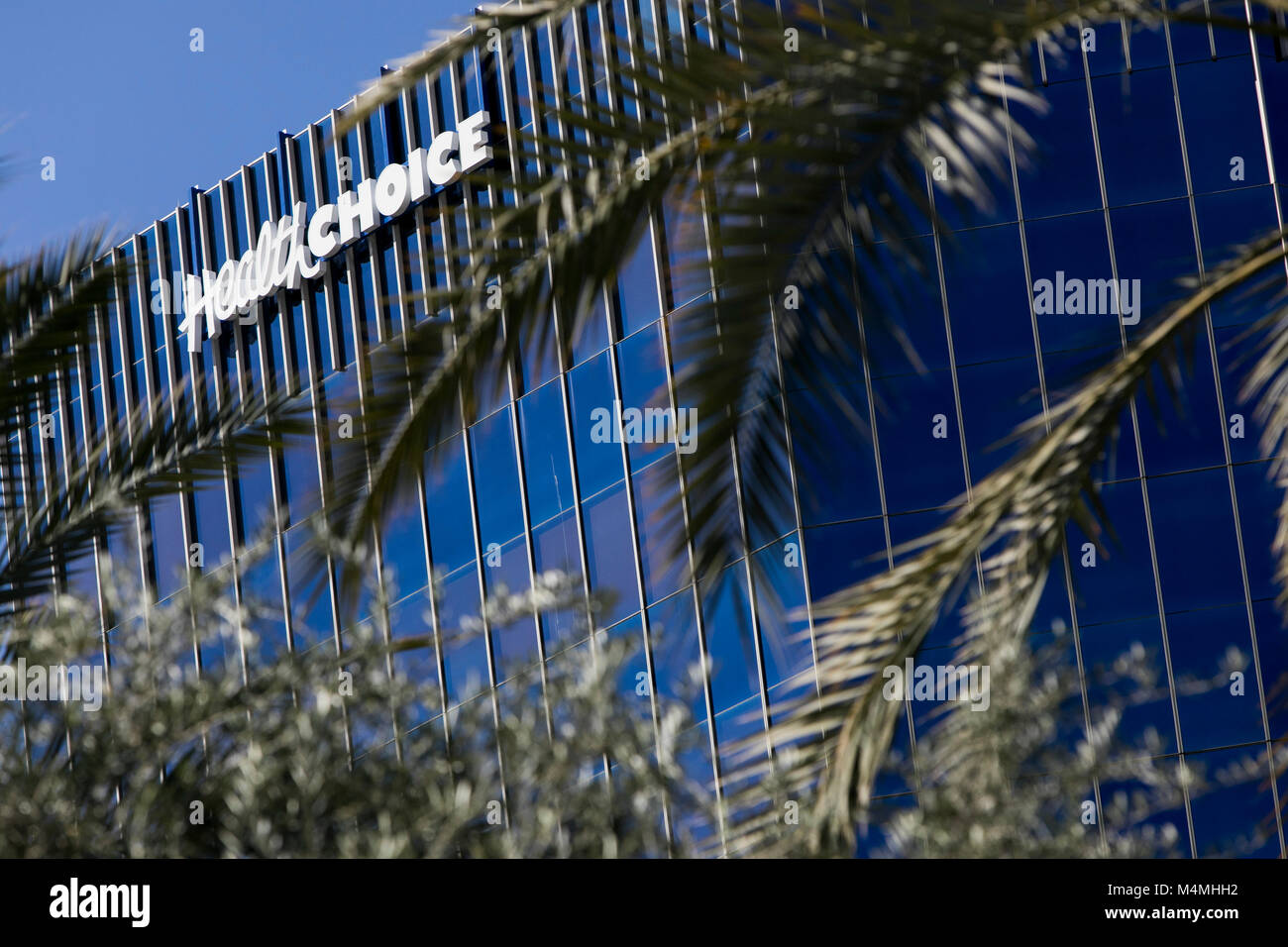 A logo sign outside of a facility occupied by Health Choice in Phoenix ...