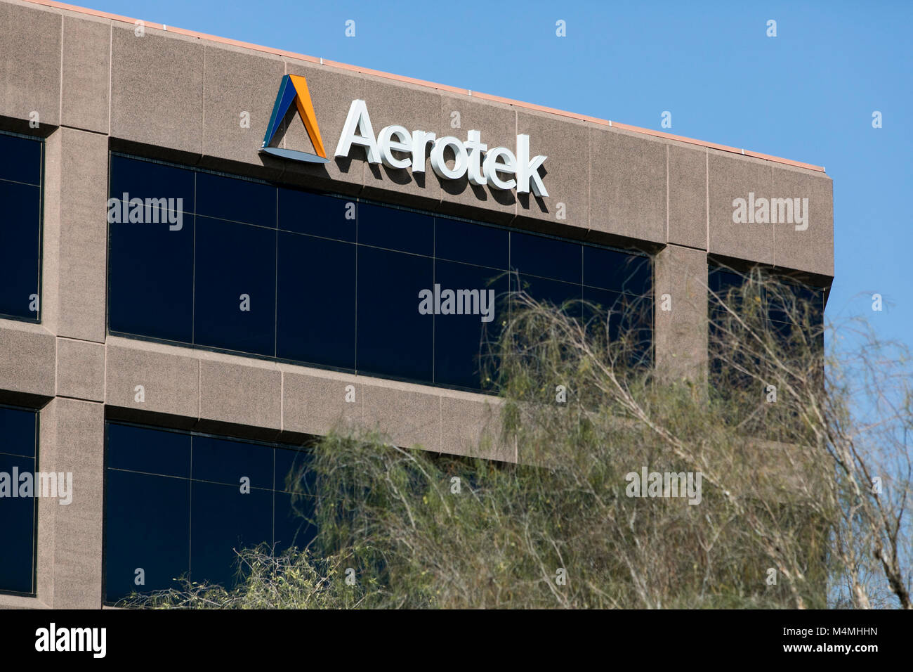 A logo sign outside of a facility occupied by TEKsystems and Aerotek in ...