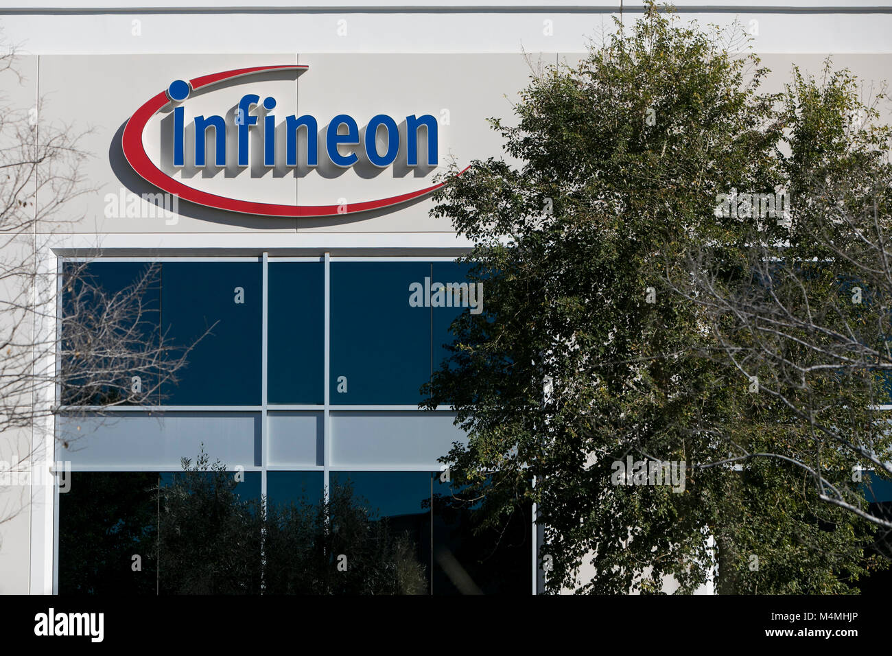 A logo sign outside of a facility occupied by Infineon Technologies in ...