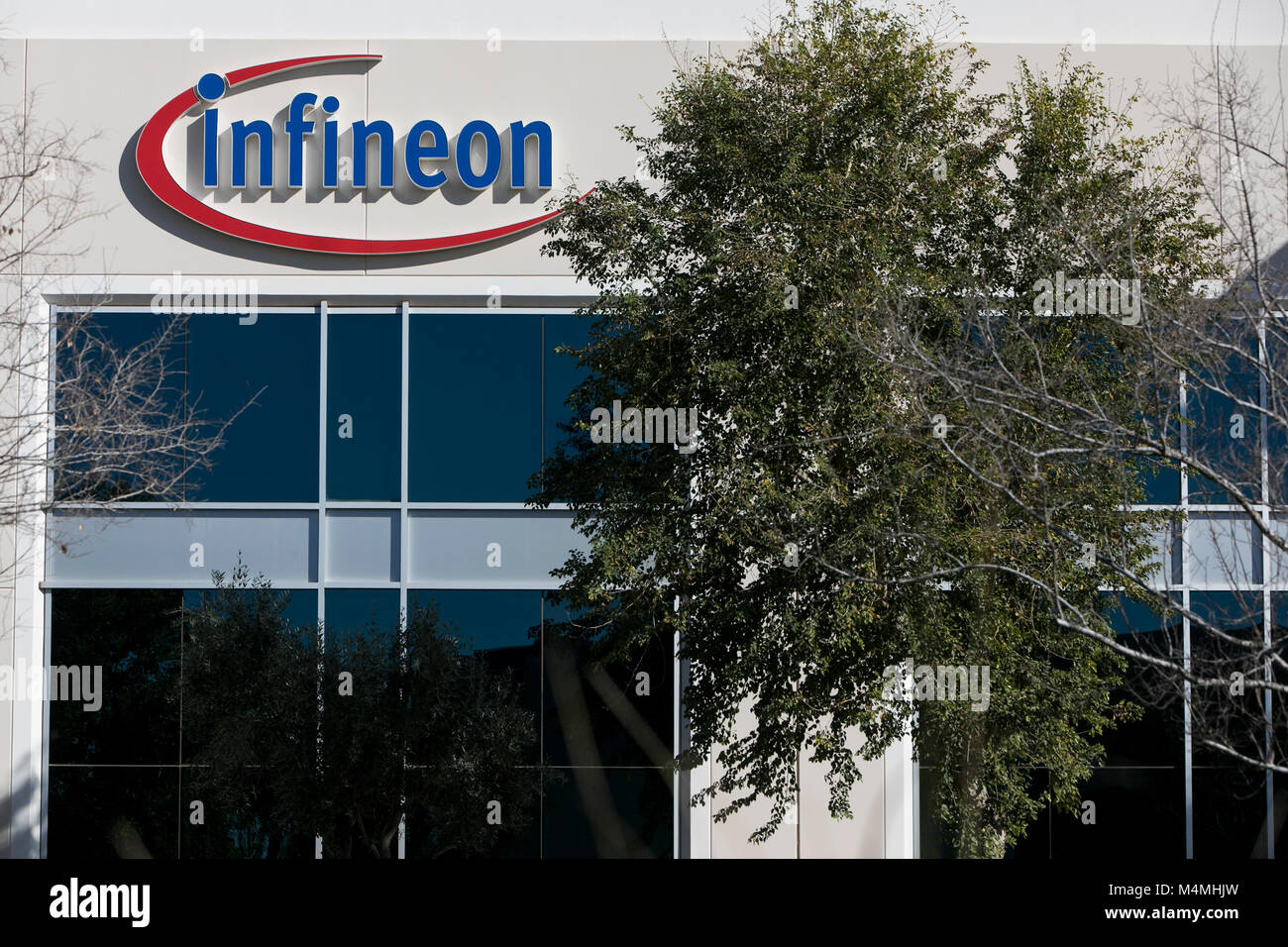 A logo sign outside of a facility occupied by Infineon Technologies in ...