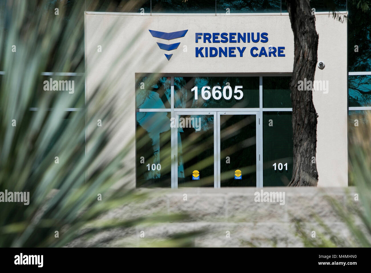 A logo sign outside of a facility occupied by Fresenius Kidney Care in ...