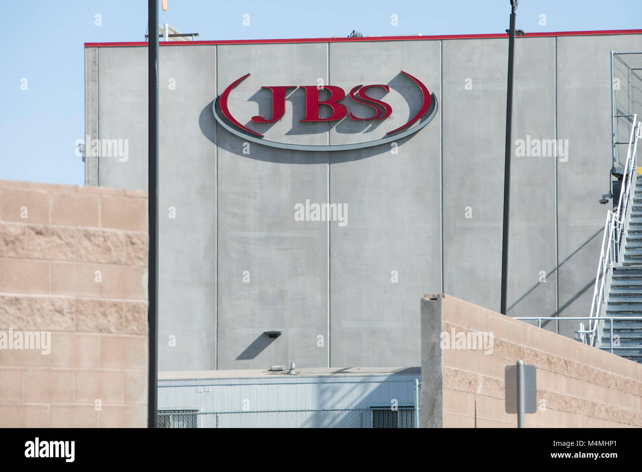 A logo sign outside of a facility occupied by JBS USA in Tolleson ...