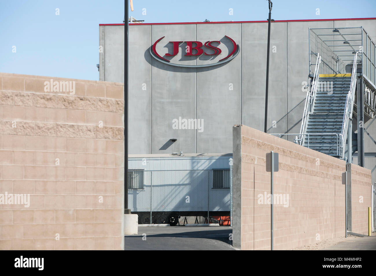 A logo sign outside of a facility occupied by JBS USA in Tolleson ...