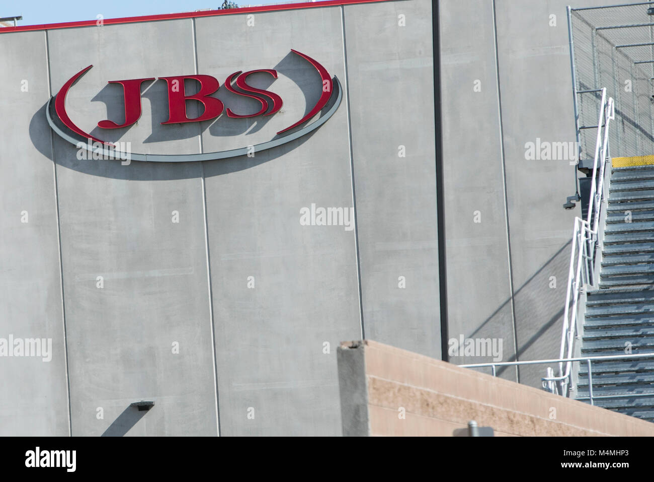 A logo sign outside of a facility occupied by JBS USA in Tolleson ...