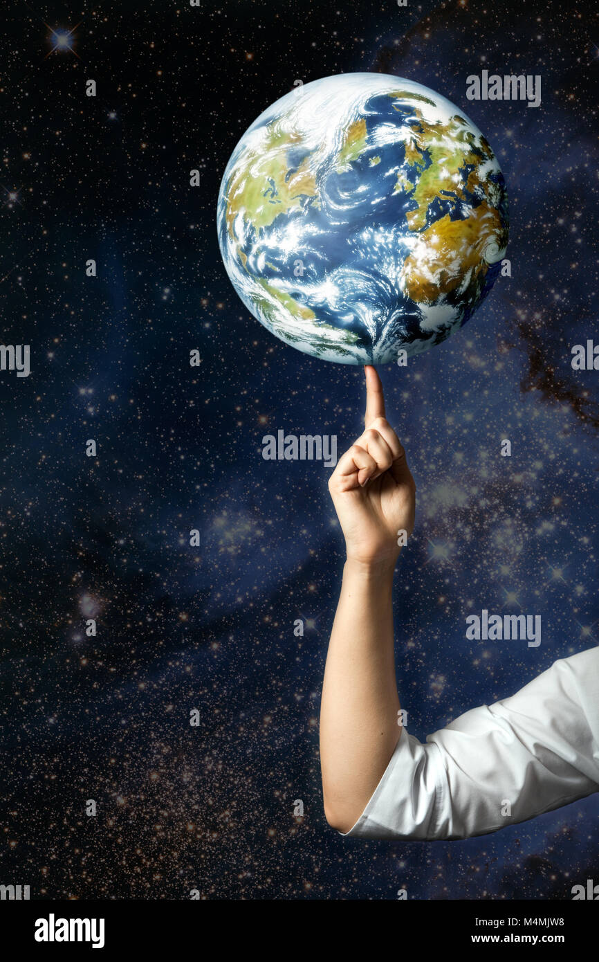 Woman balancing the planet earth on one finger Stock Photo - Alamy