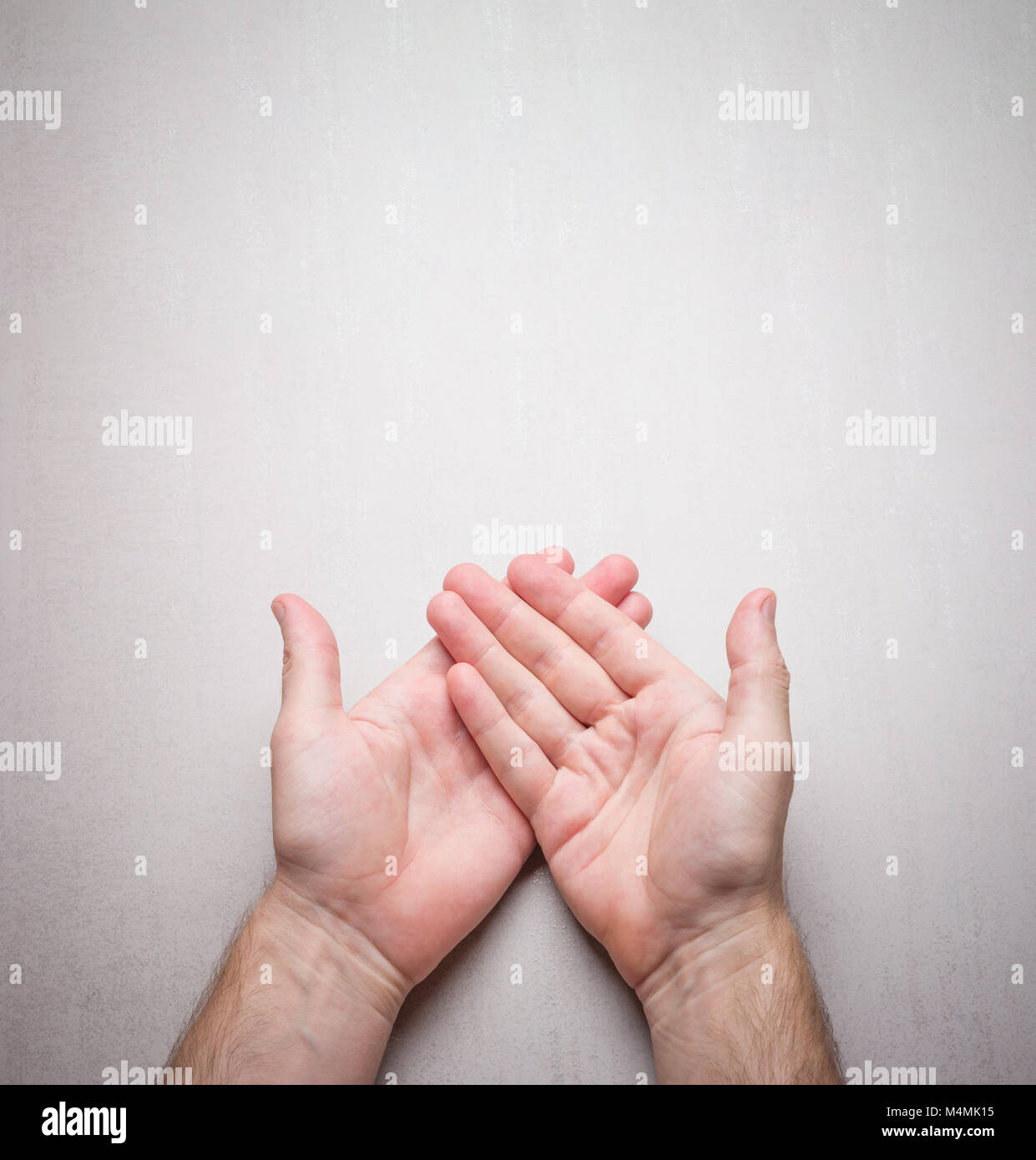 mens open palms on grey background top view with space for text. mock ...