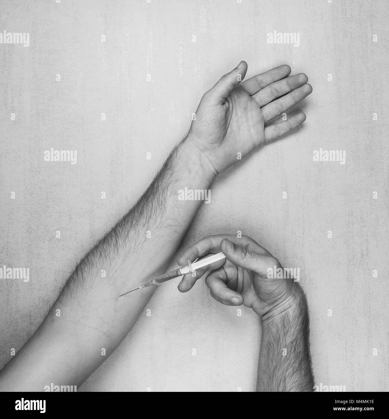 hands of man making himself an injection of disposable medical syringe ...