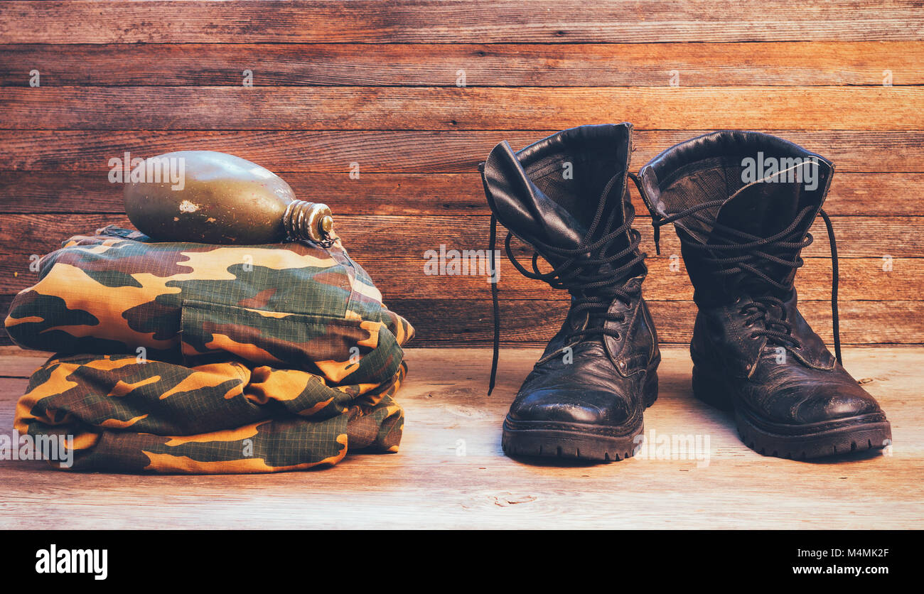old leather black men boots ankle boots, military uniforms and a flask ...
