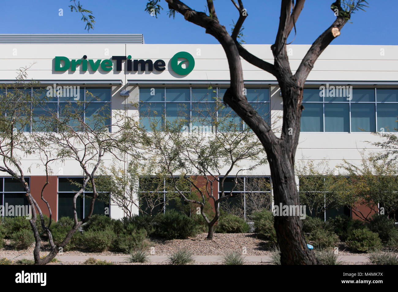 A logo sign outside of the headquarters of the DriveTime Automotive ...