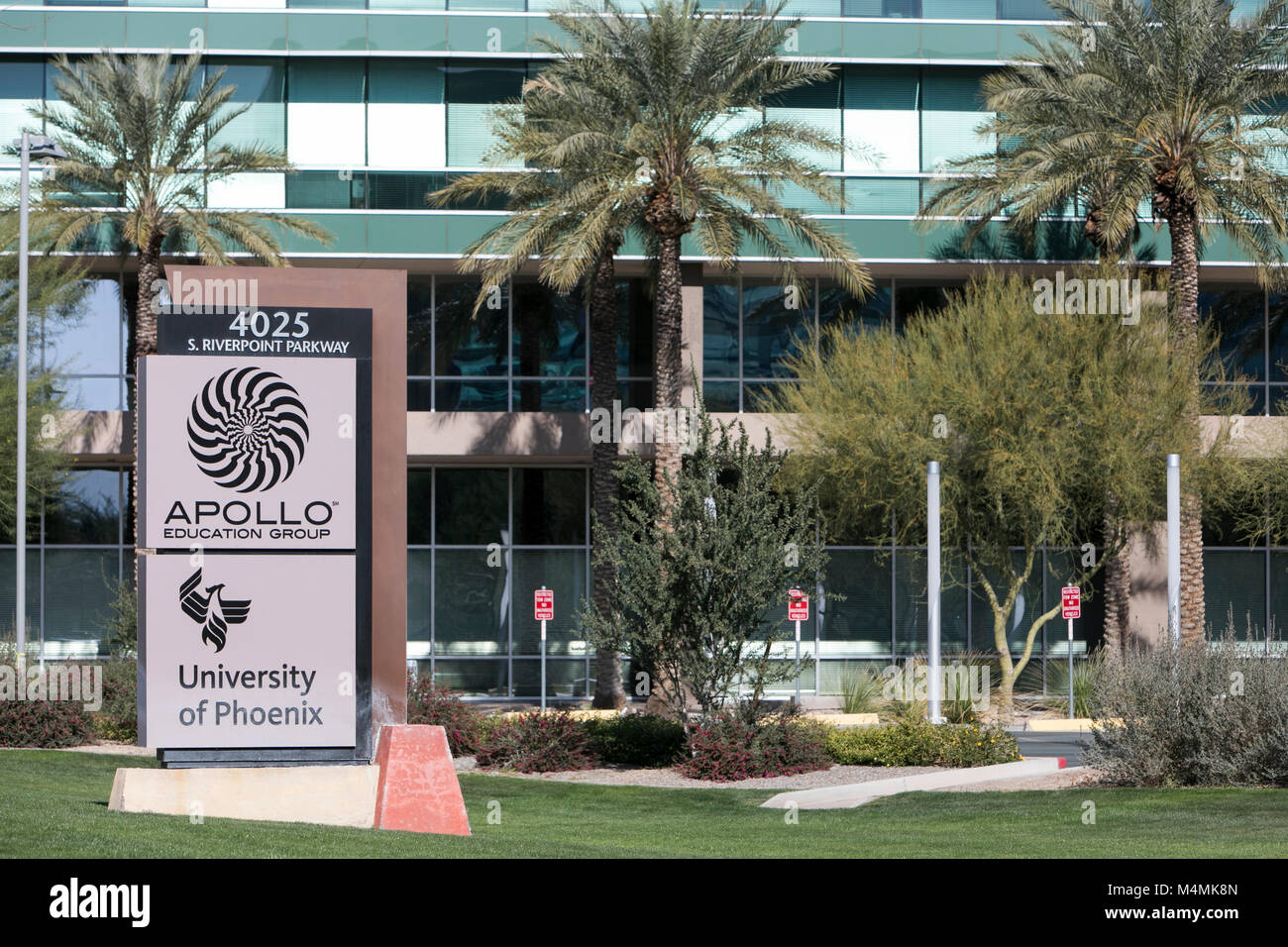 A logo sign outside of the headquarters of the Apollo Education Group ...