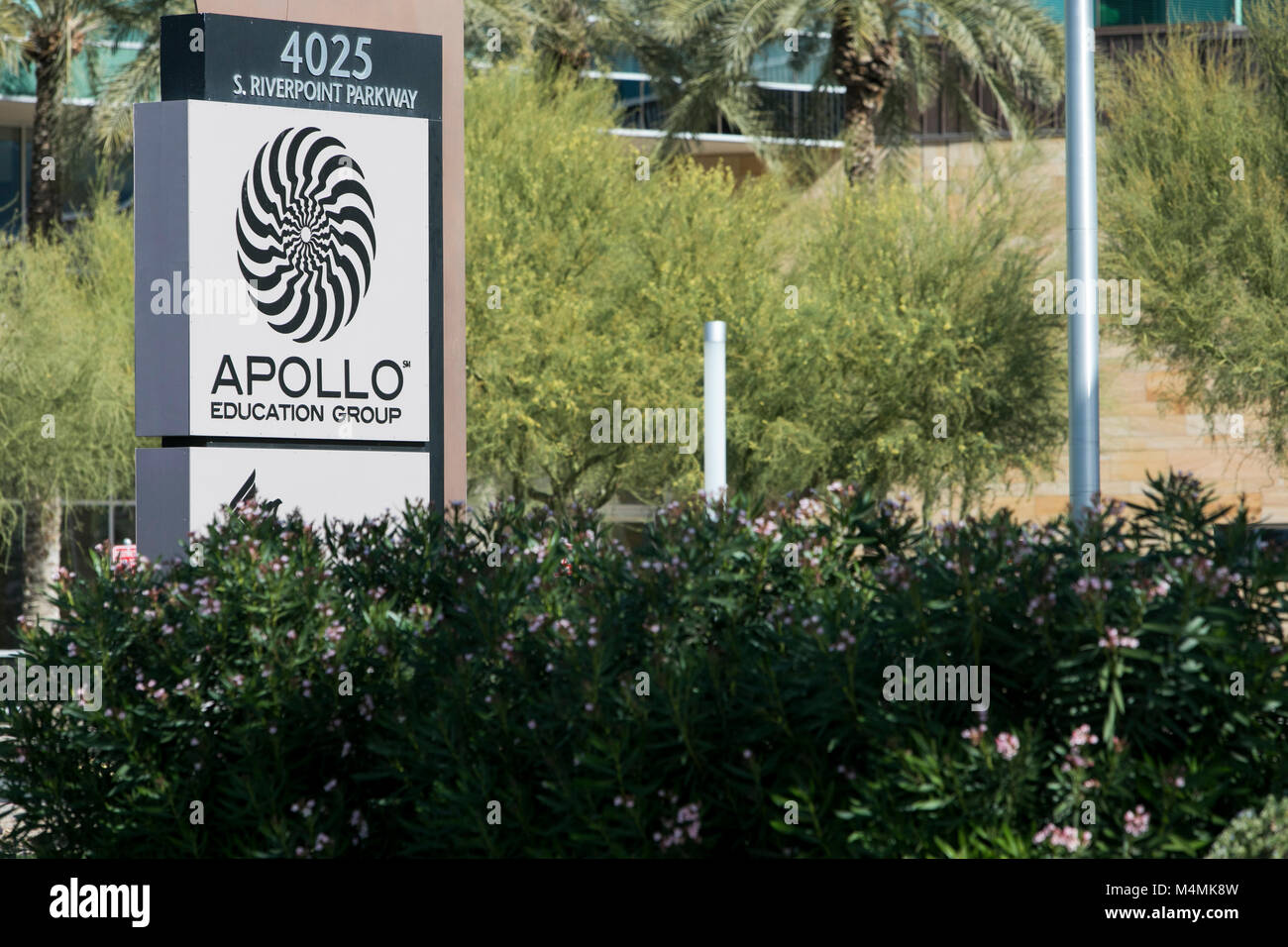 A logo sign outside of the headquarters of the Apollo Education Group ...