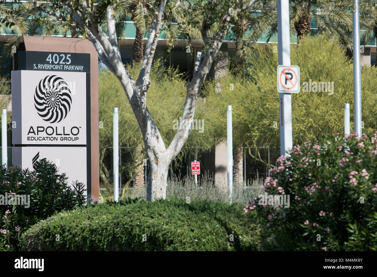 A logo sign outside of the headquarters of the Apollo Education Group ...