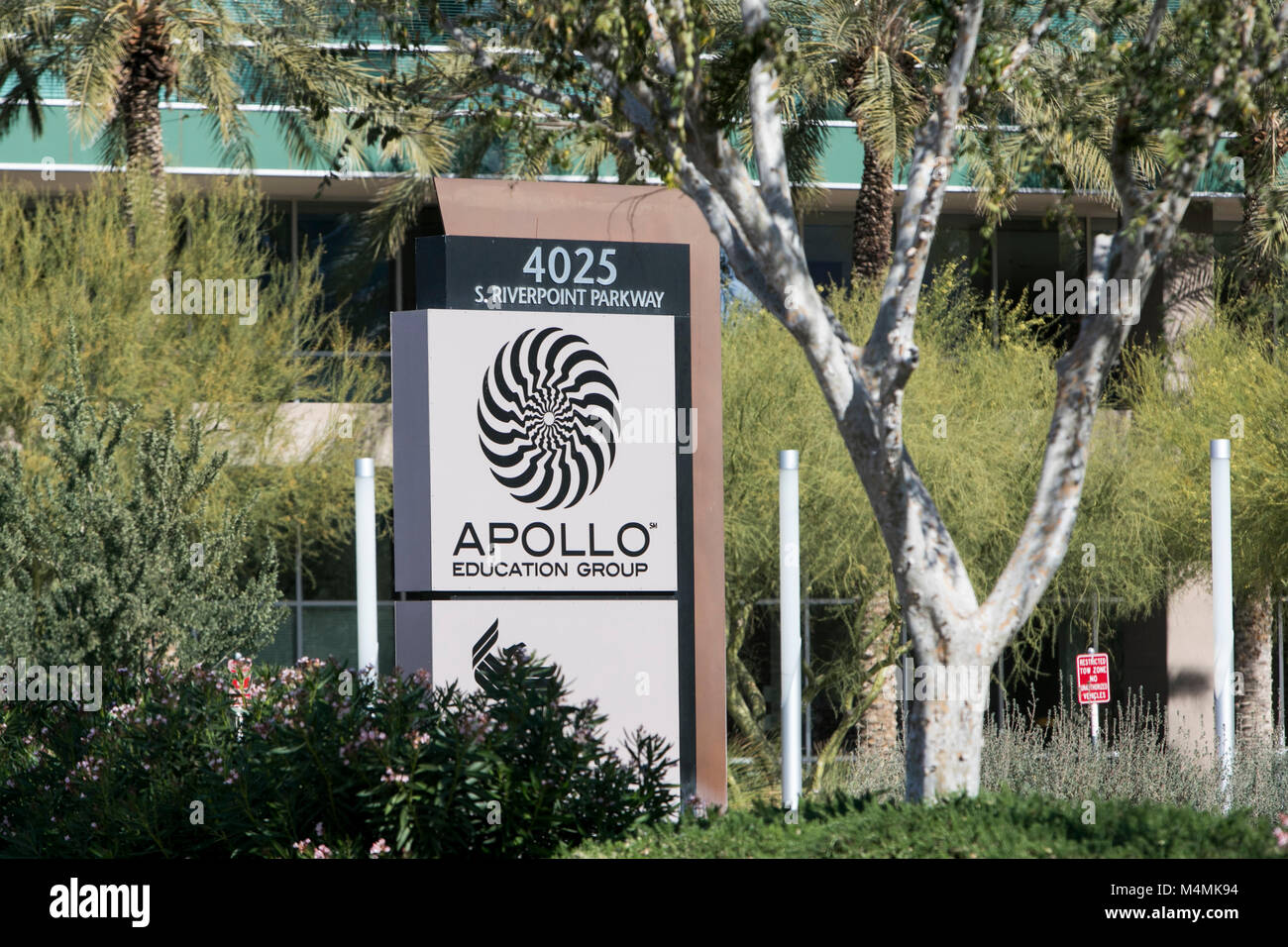 A logo sign outside of the headquarters of the Apollo Education Group ...