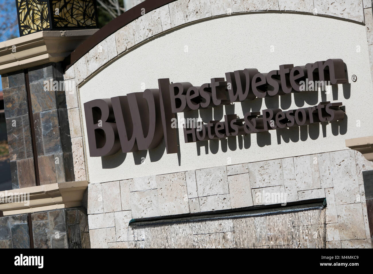 A logo sign outside of the headquarters of Best Western International ...