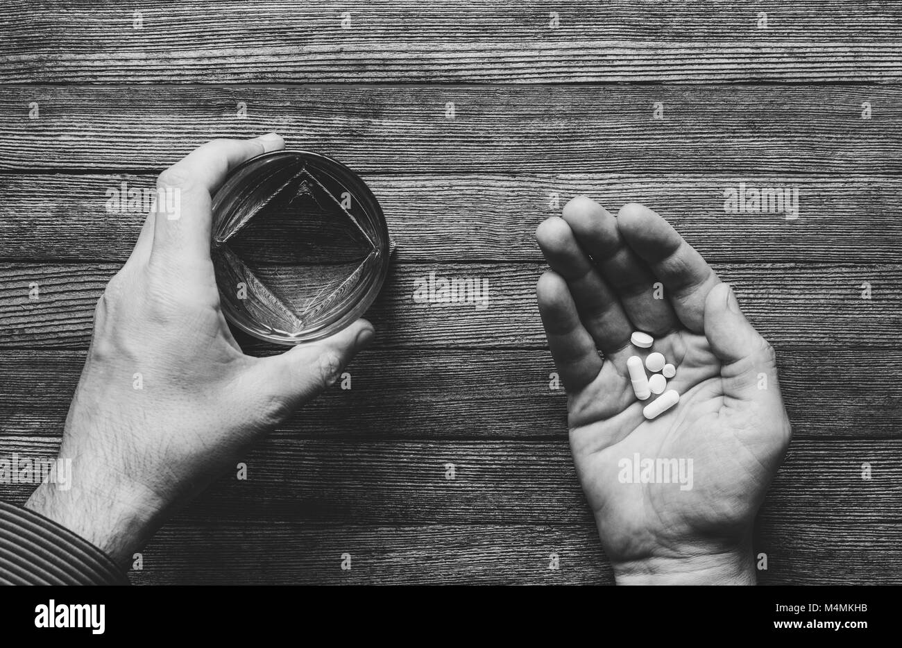 the man is going to eat pills and capsules and taken with water, black ...